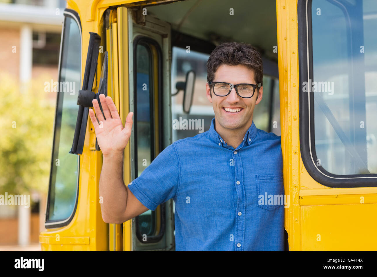 Portrait of teacher waving hand from bus Stock Photo - Alamy