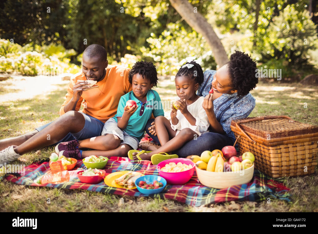 Happy family eating together Stock Photo - Alamy