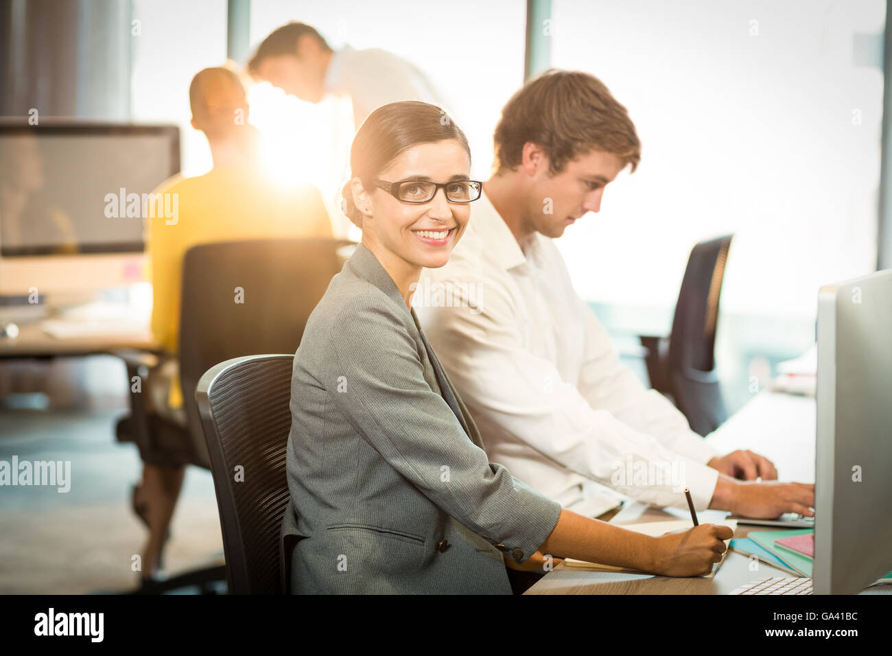 Portrait of businesswoman having a discussion with coworker Stock Photo ...