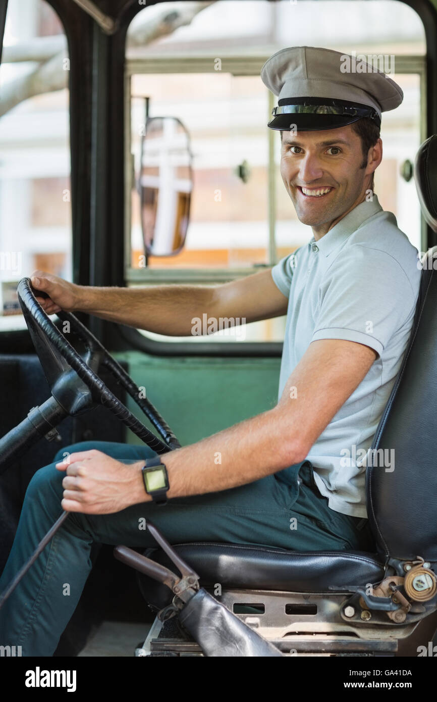 Smiling bus driver driving a bus Stock Photo - Alamy Smiling bus driver driving a bus Stock Photo - Alamy