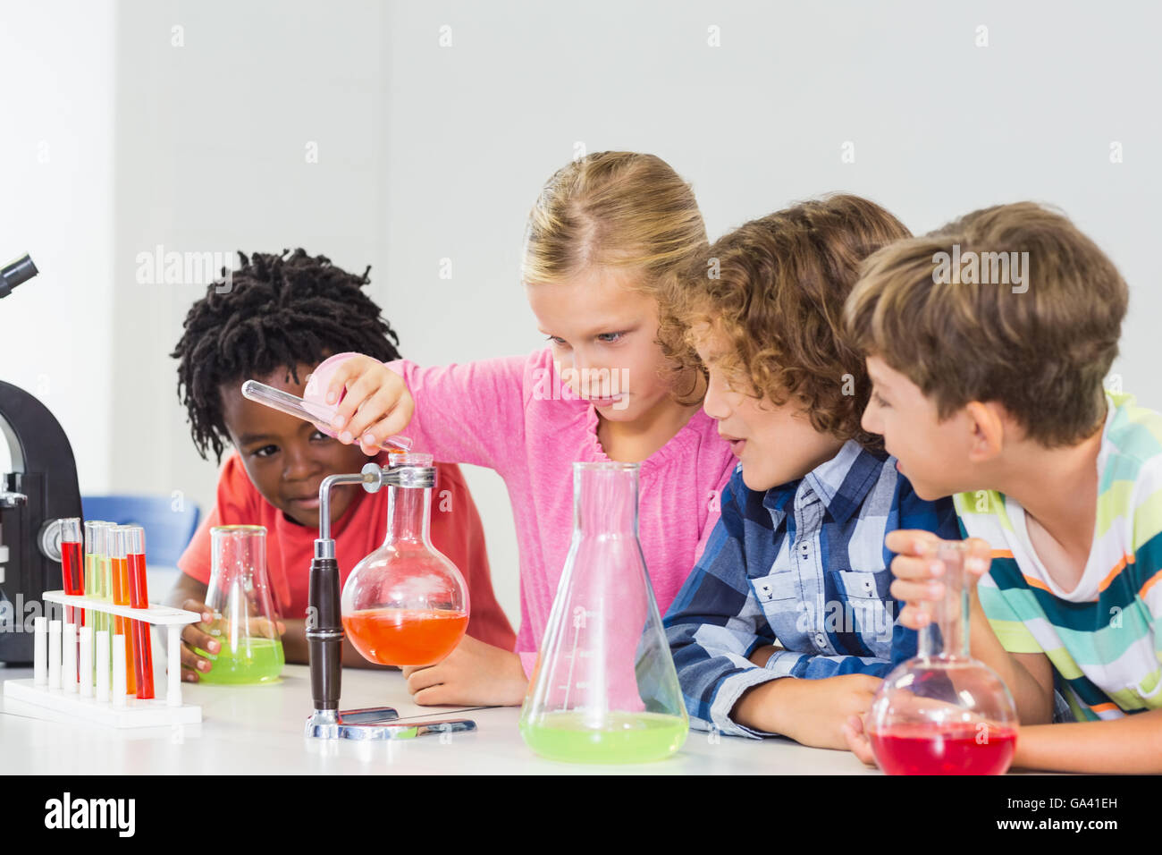 Kids doing a chemical experiment in laboratory Stock Photo - Alamy