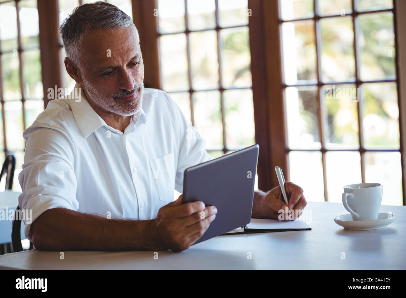Man using tablet and notebook Stock Photo - Alamy
