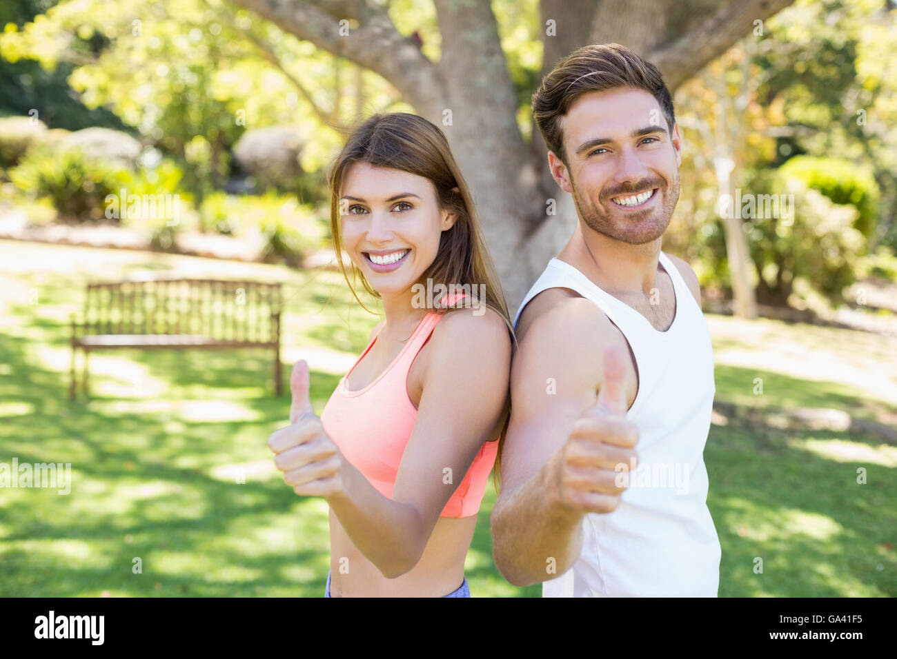 Portrait of couple standing back to back Stock Photo - Alamy
