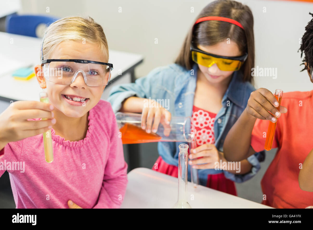 Kids doing a chemical experiment in laboratory Stock Photo - Alamy