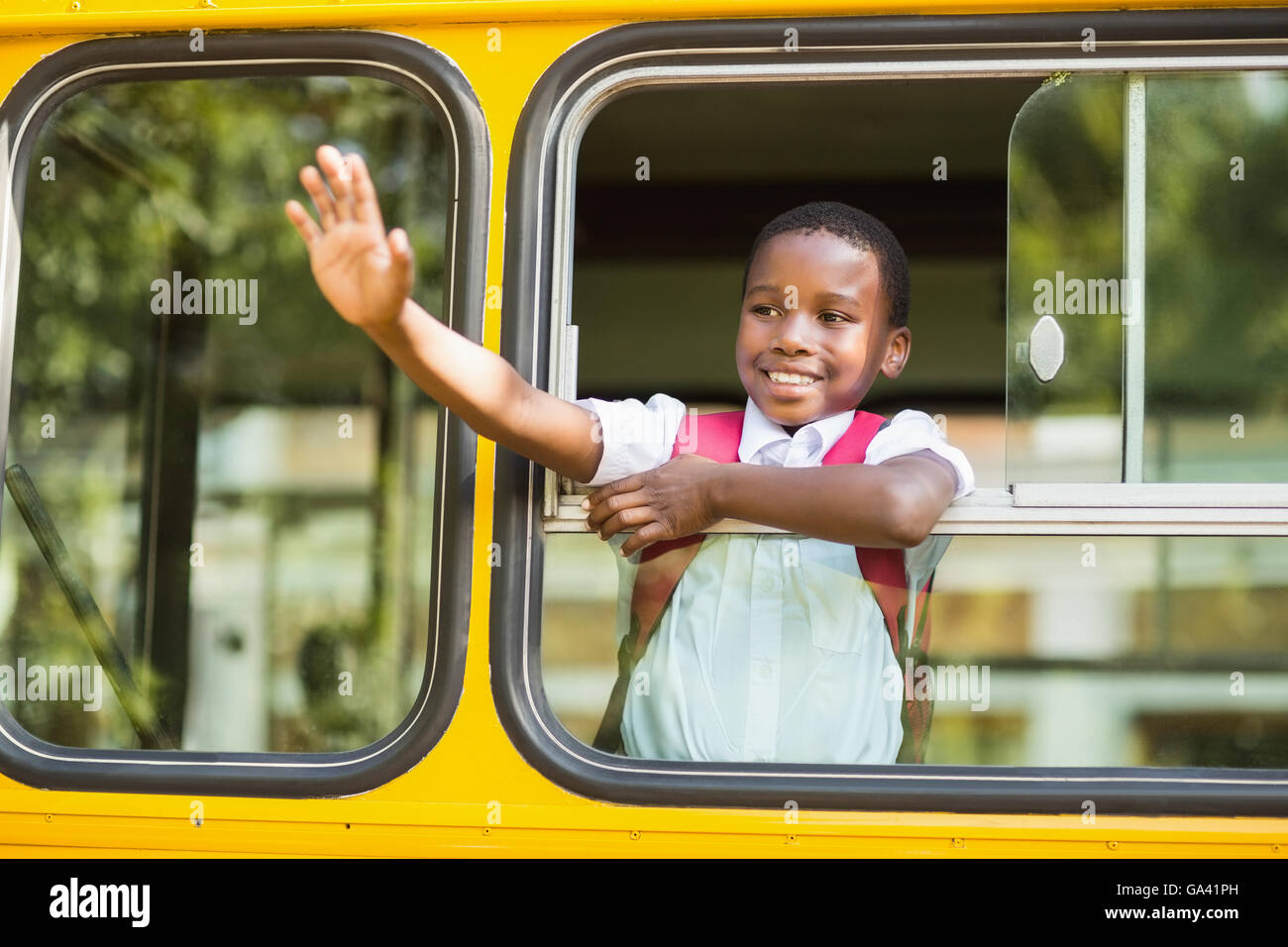 Schoolboy waving hand from bus Stock Photo - Alamy