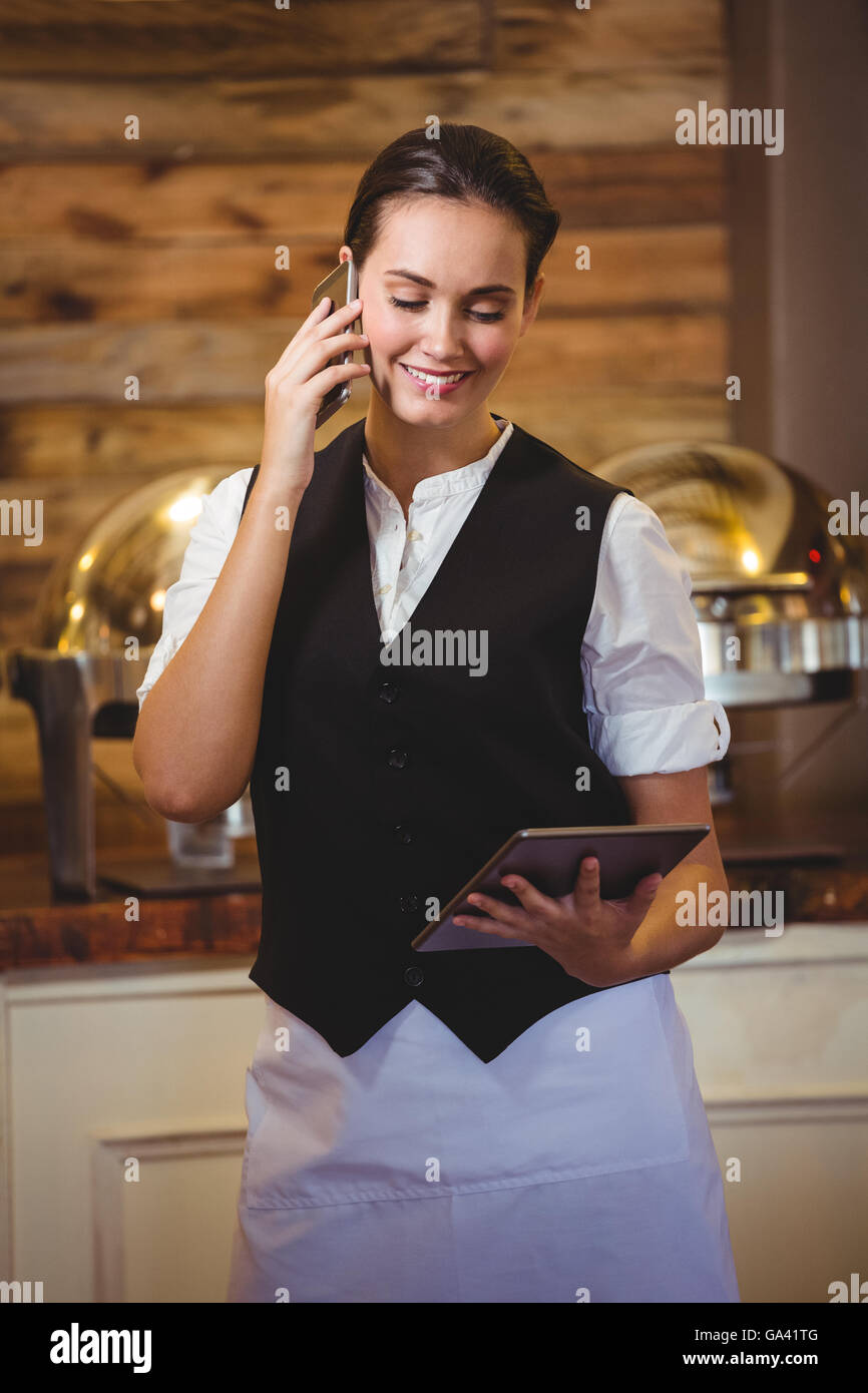 Waitress making a phone call Stock Photo - Alamy