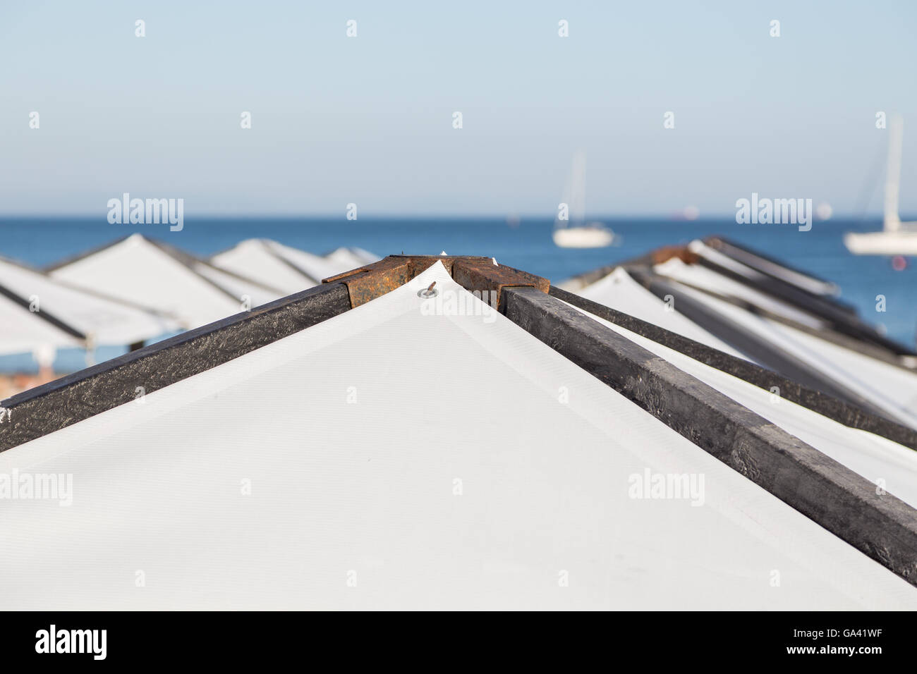 triangular umbrellas on seaside beach for relaxation and sun protection ...