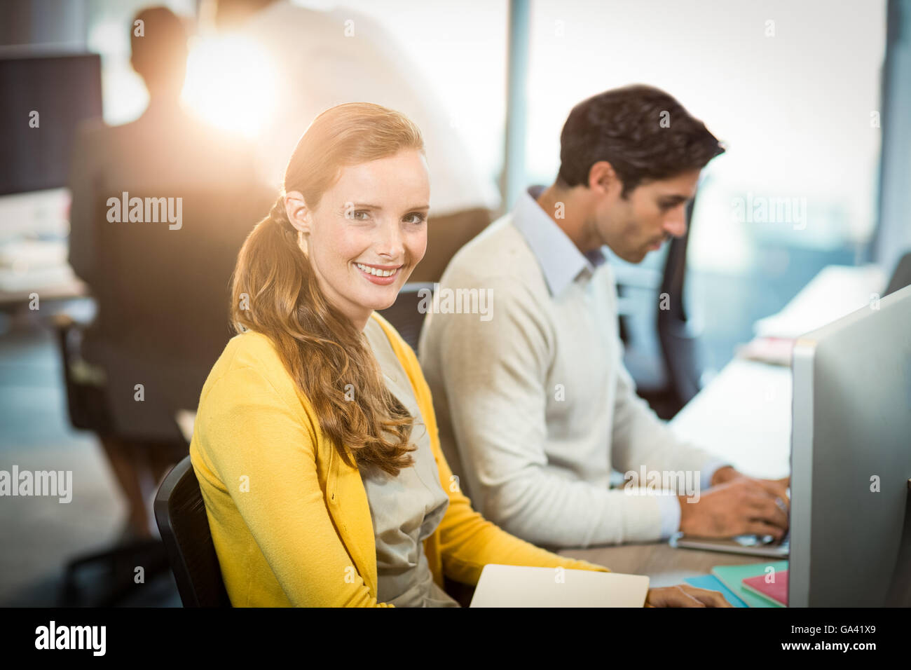 Portrait of woman working on computer Stock Photo - Alamy