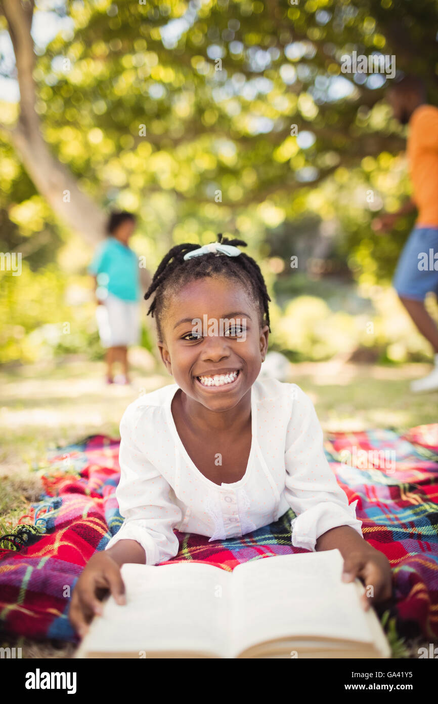 Happy girl reading a book Stock Photo - Alamy