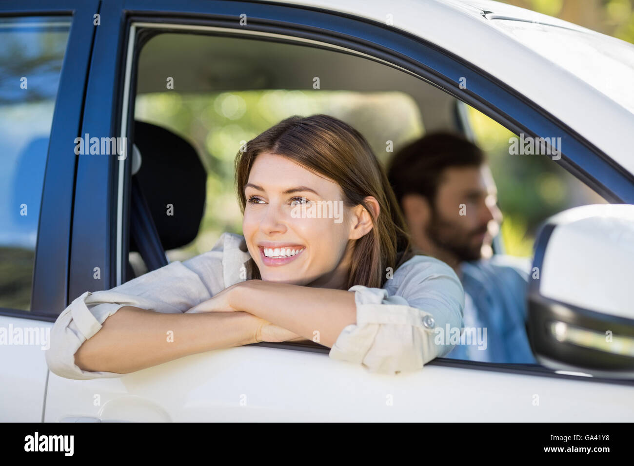 Thoughtful woman looking out from car window Stock Photo - Alamy