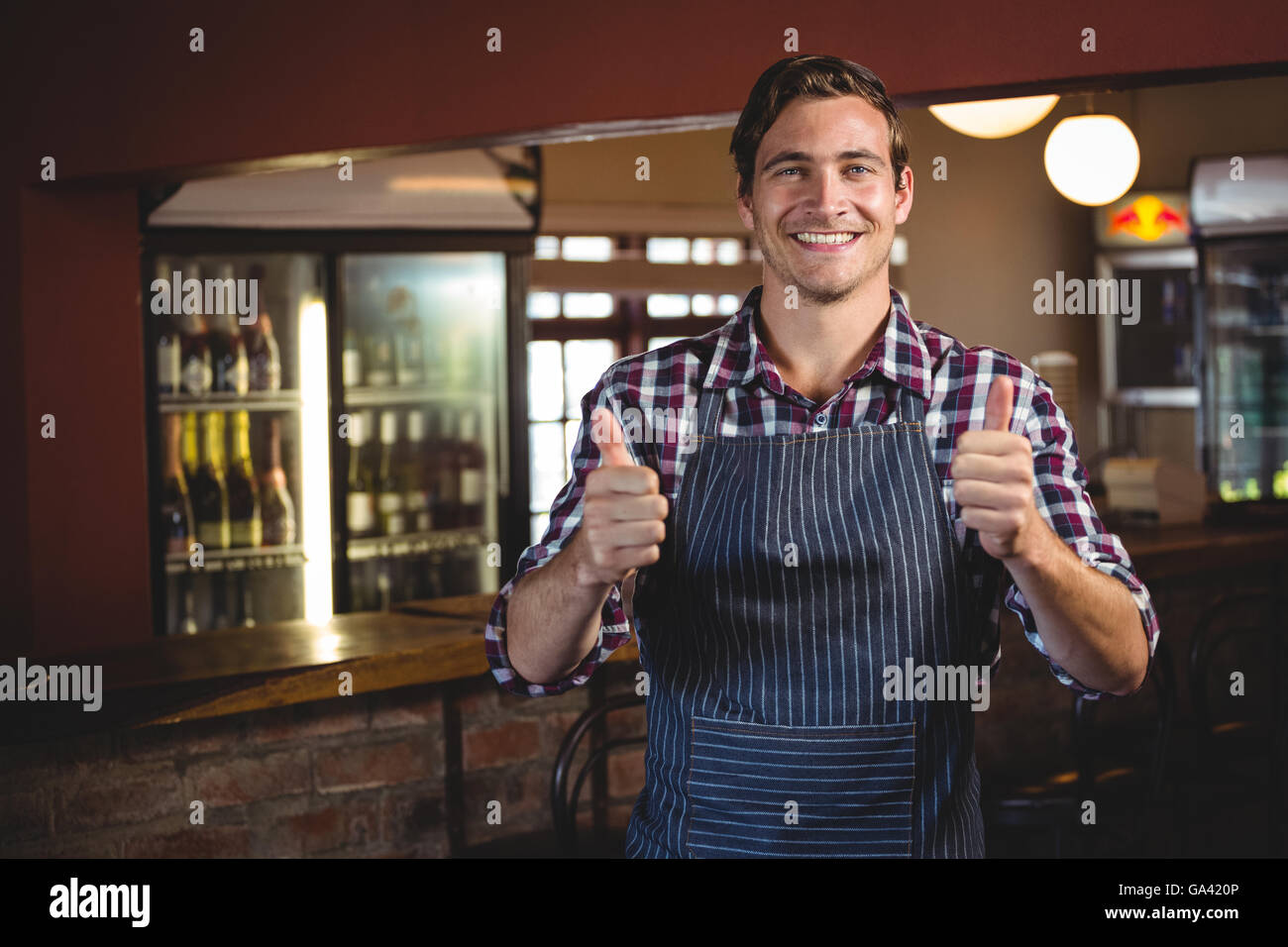 Smiling waiter with thumbs up Stock Photo - Alamy