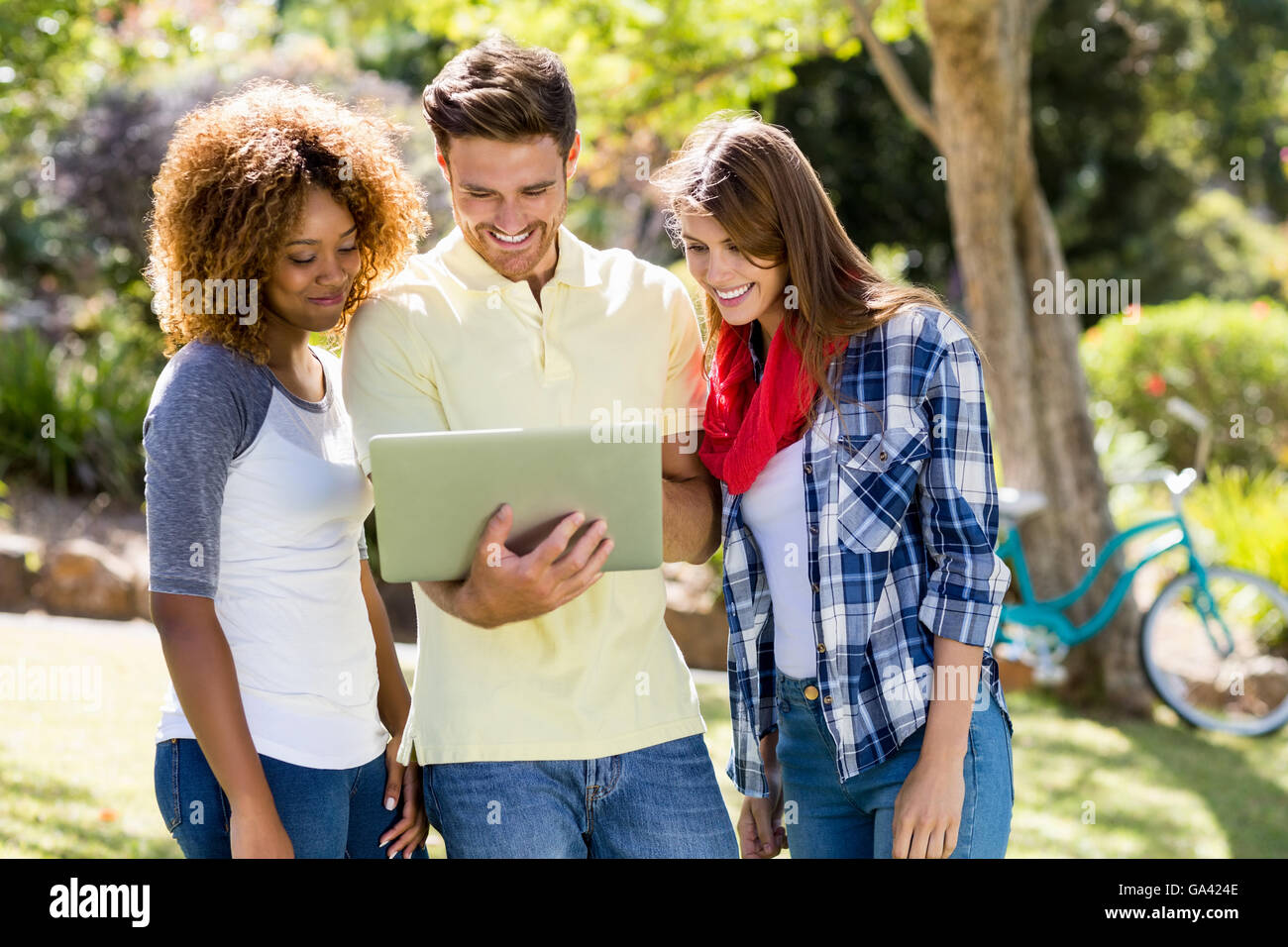 Group of friends using laptop Stock Photo - Alamy