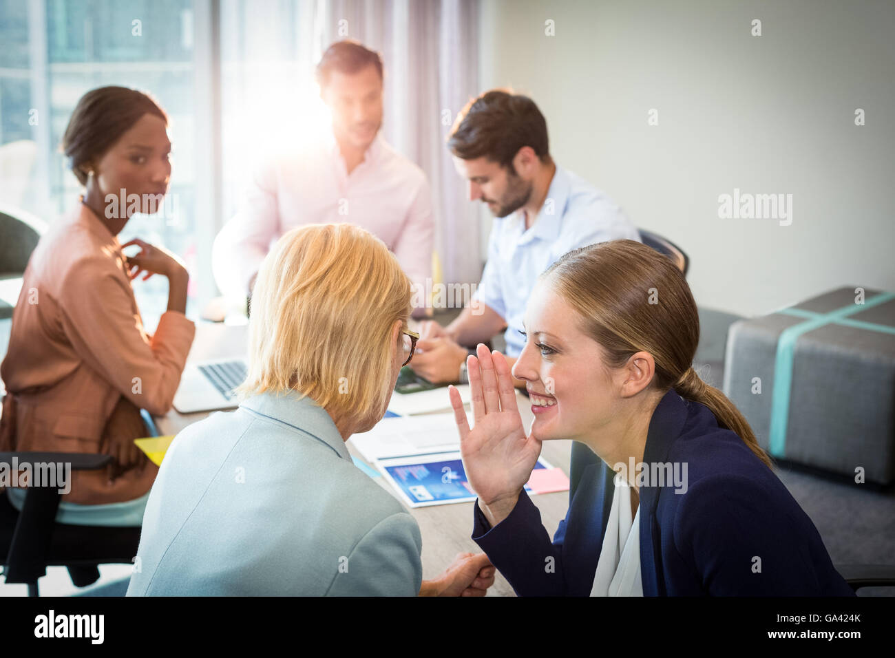 Business people gossiping during meeting Stock Photo - Alamy