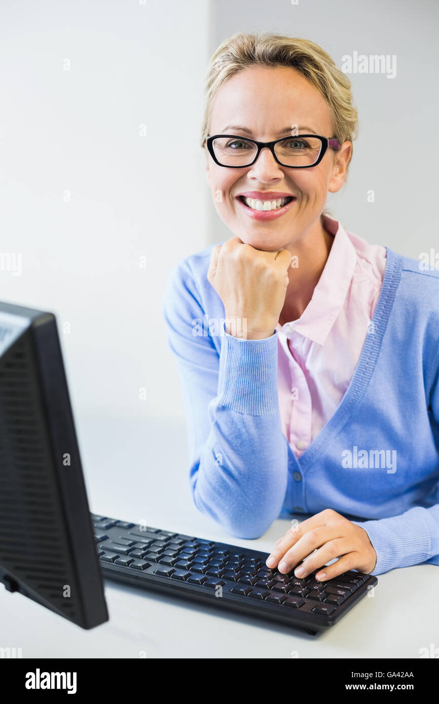 Teacher working on computer in classroom Stock Photo - Alamy
