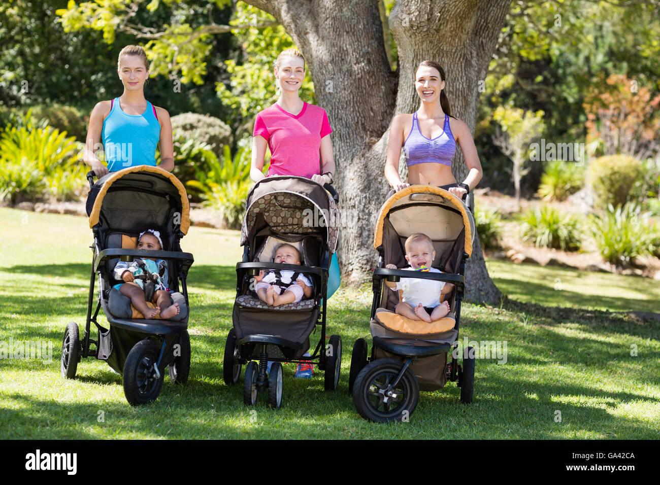 Women standing with the baby stroller Stock Photo - Alamy
