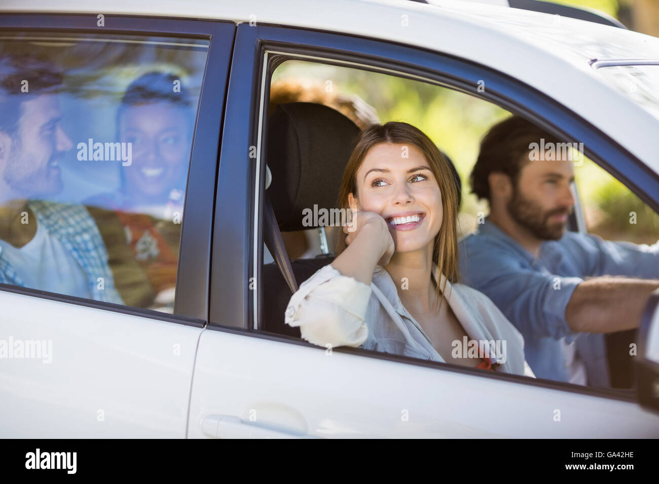 Beautiful woman looking out from car window Stock Photo - Alamy
