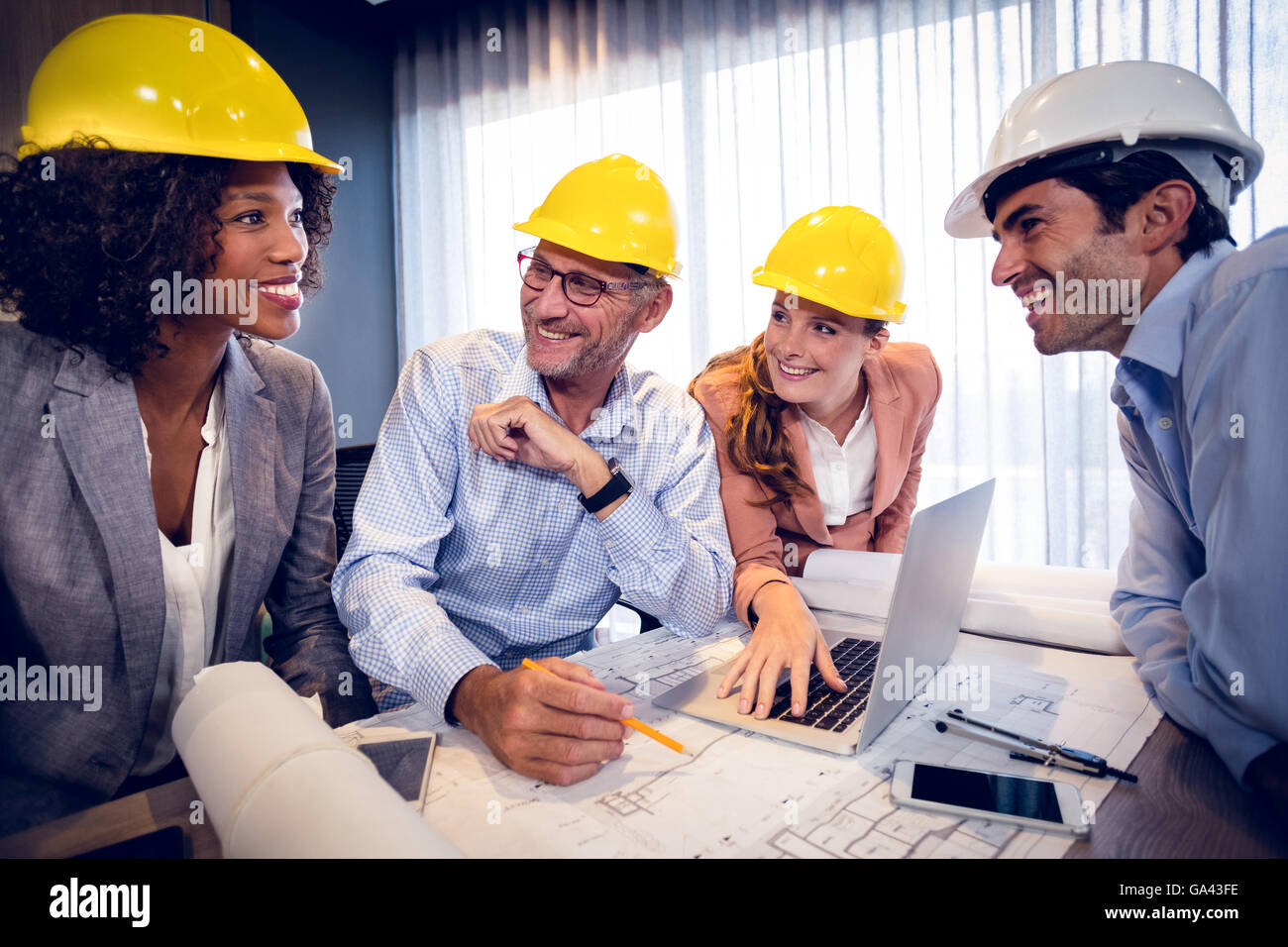 Smiling architects interacting with each other Stock Photo - Alamy