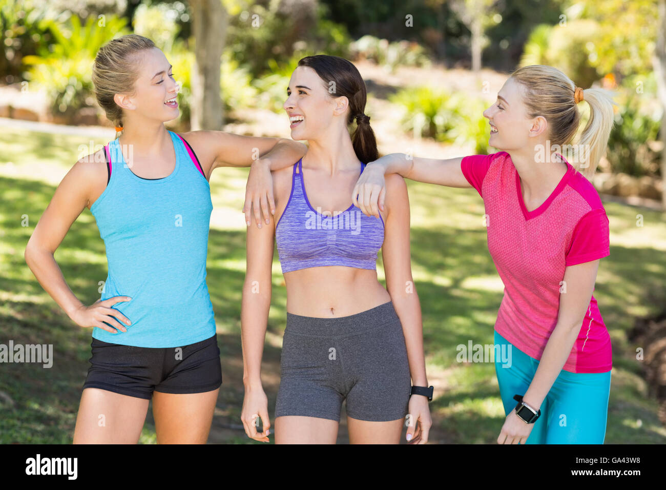 Young women standing and smiling Stock Photo - Alamy