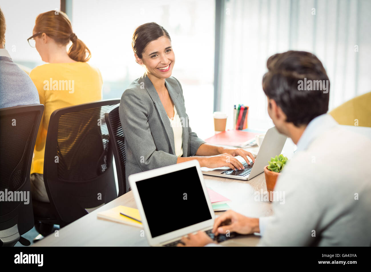 Business people working on laptop Stock Photo - Alamy