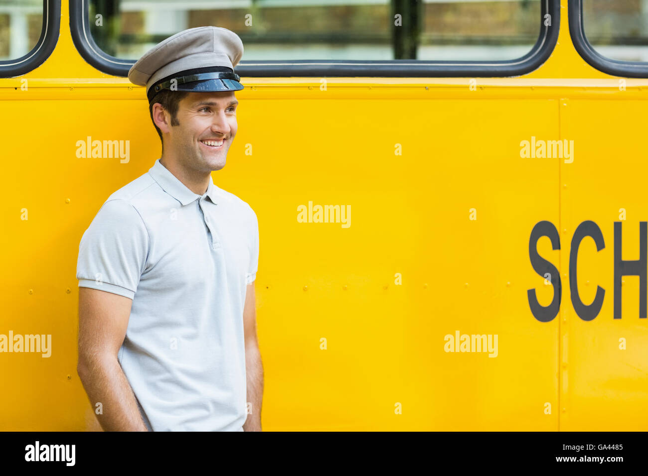 Bus driver smiling in front of bus Stock Photo - Alamy