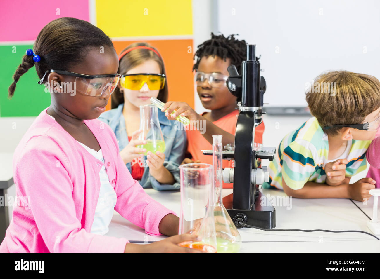 Kids doing a chemical experiment in laboratory Stock Photo - Alamy