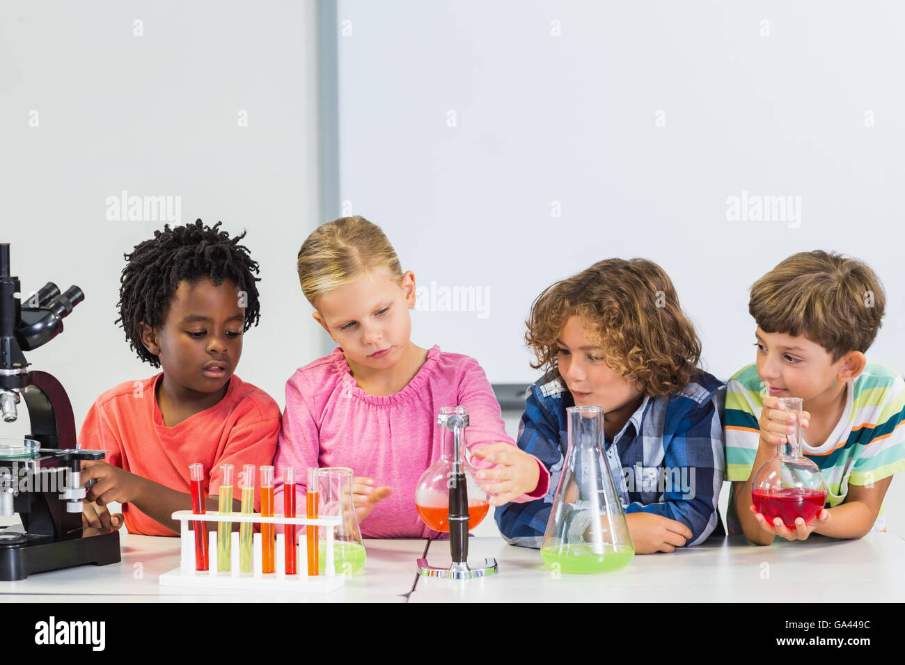 Kids doing a chemical experiment in laboratory Stock Photo - Alamy