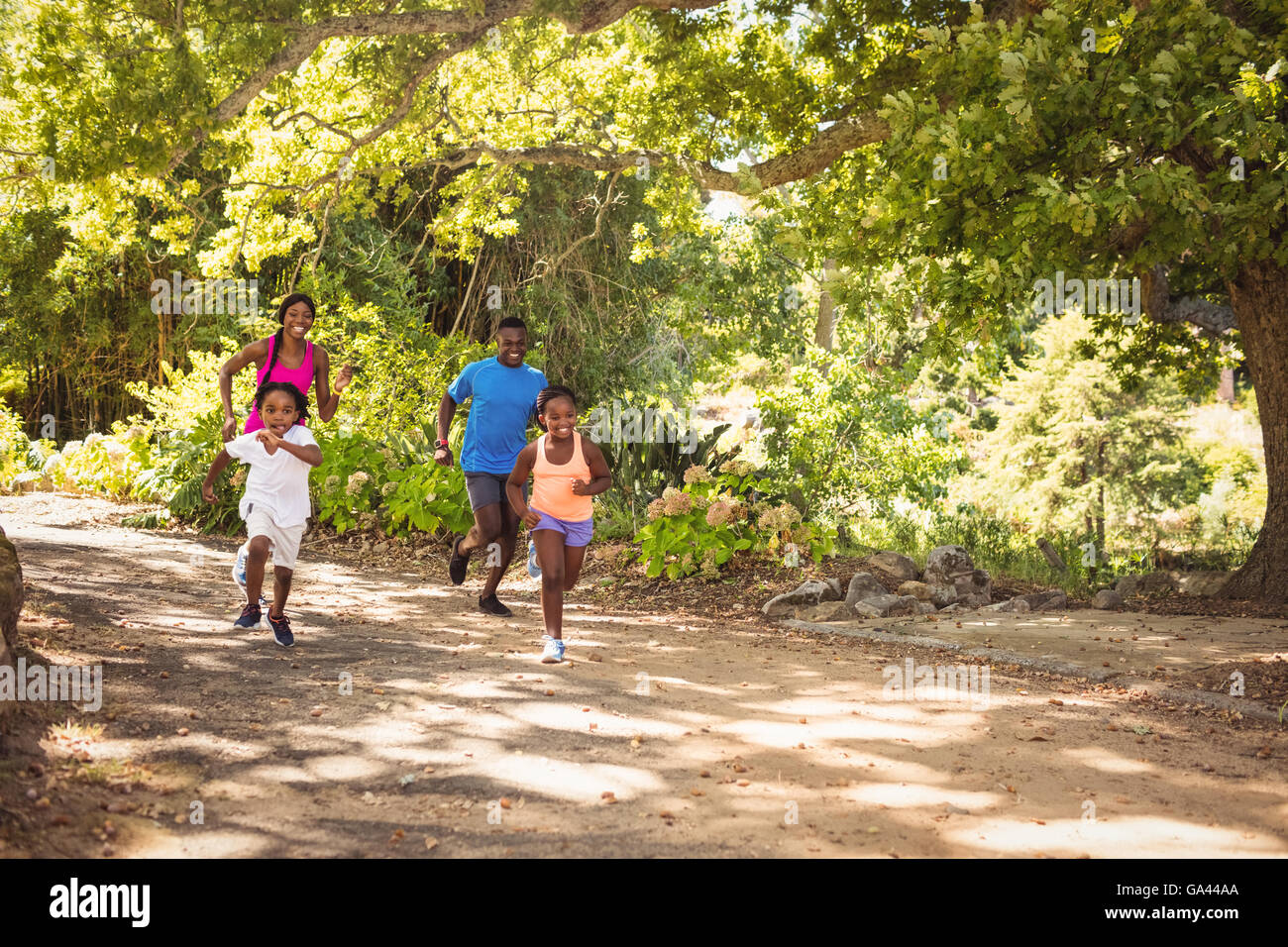 Happy family running together Stock Photo - Alamy