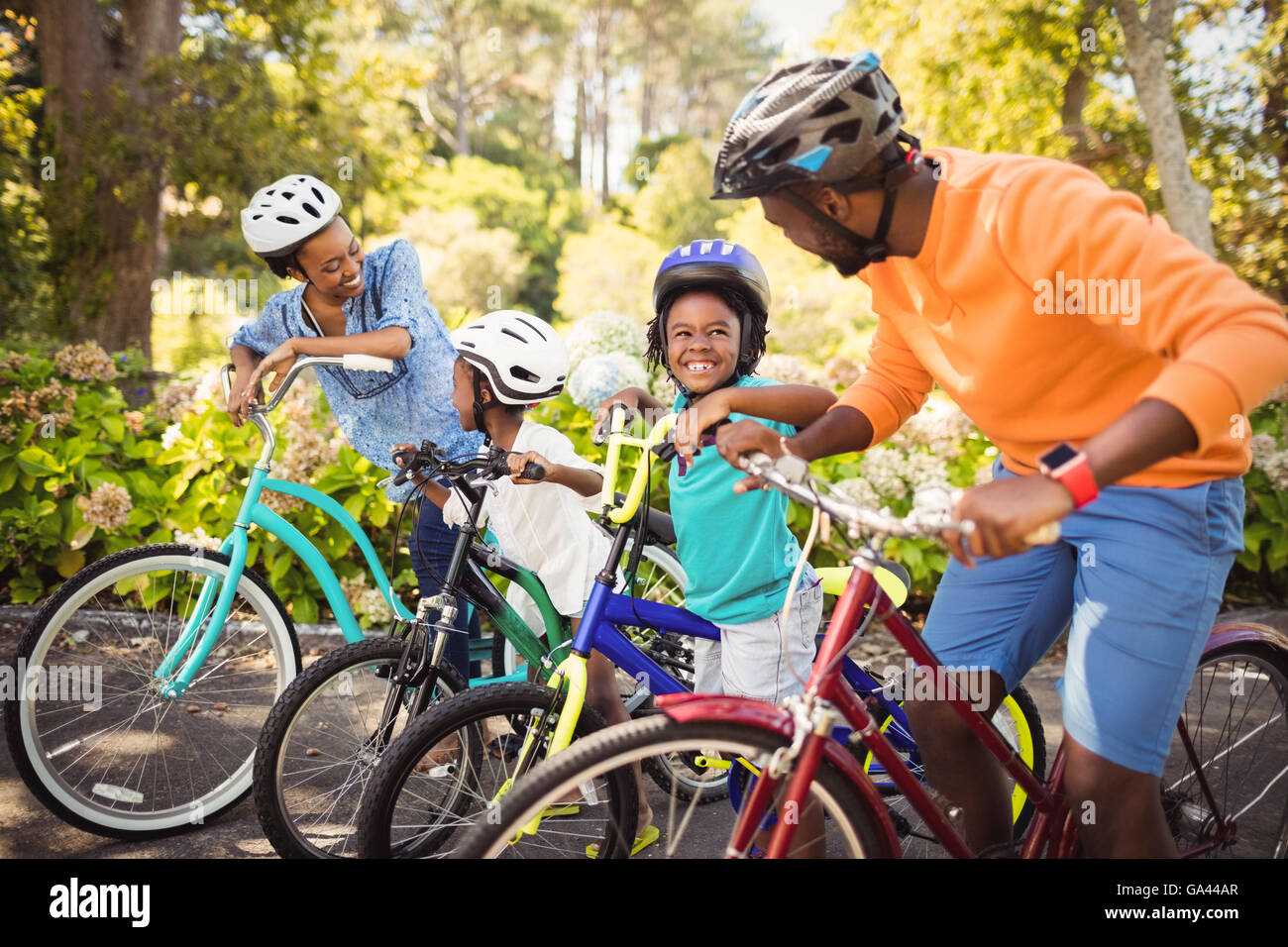 Happy family doing bicycle Stock Photo - Alamy