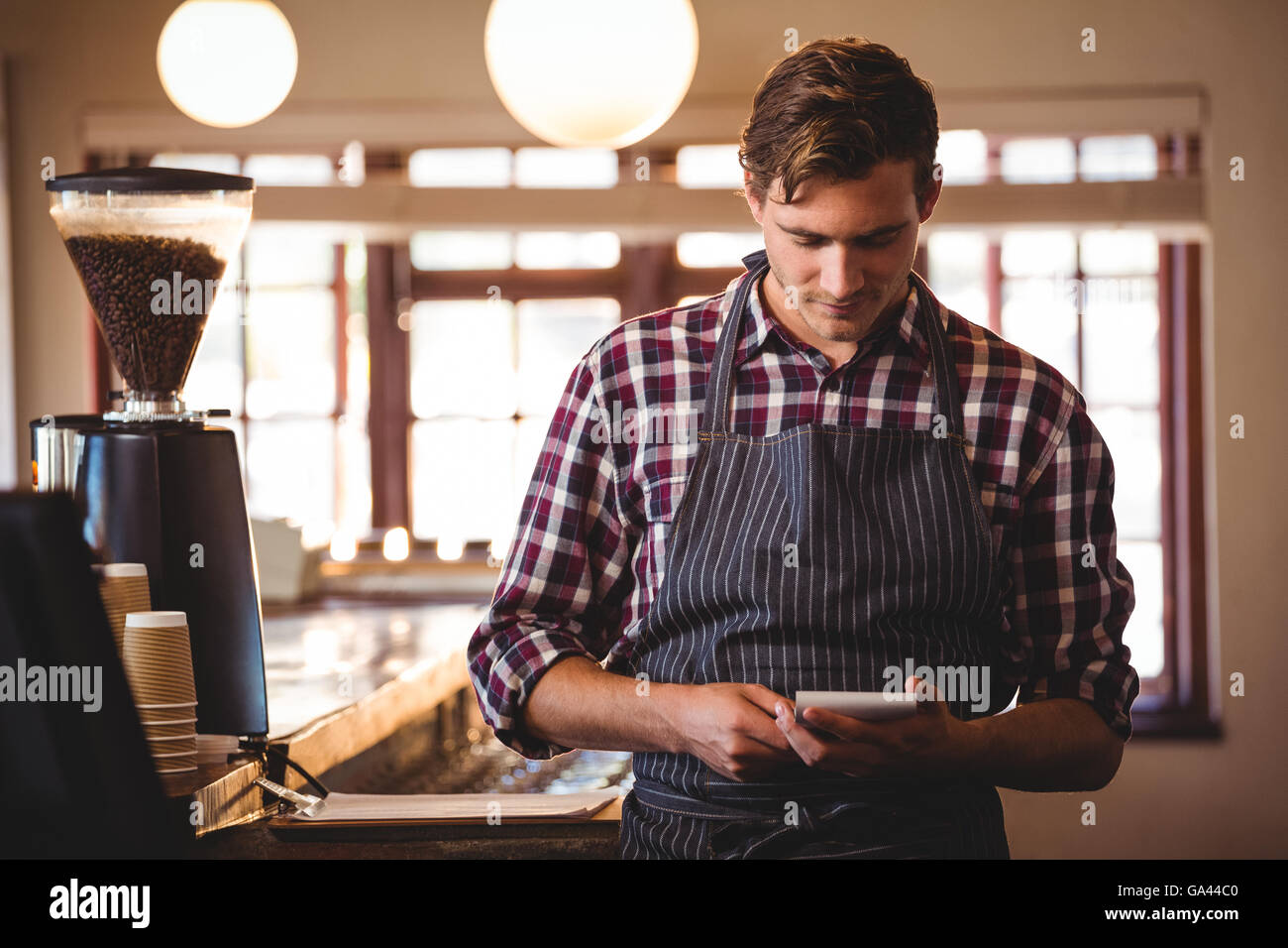 Waiter standing with notepad Stock Photo - Alamy