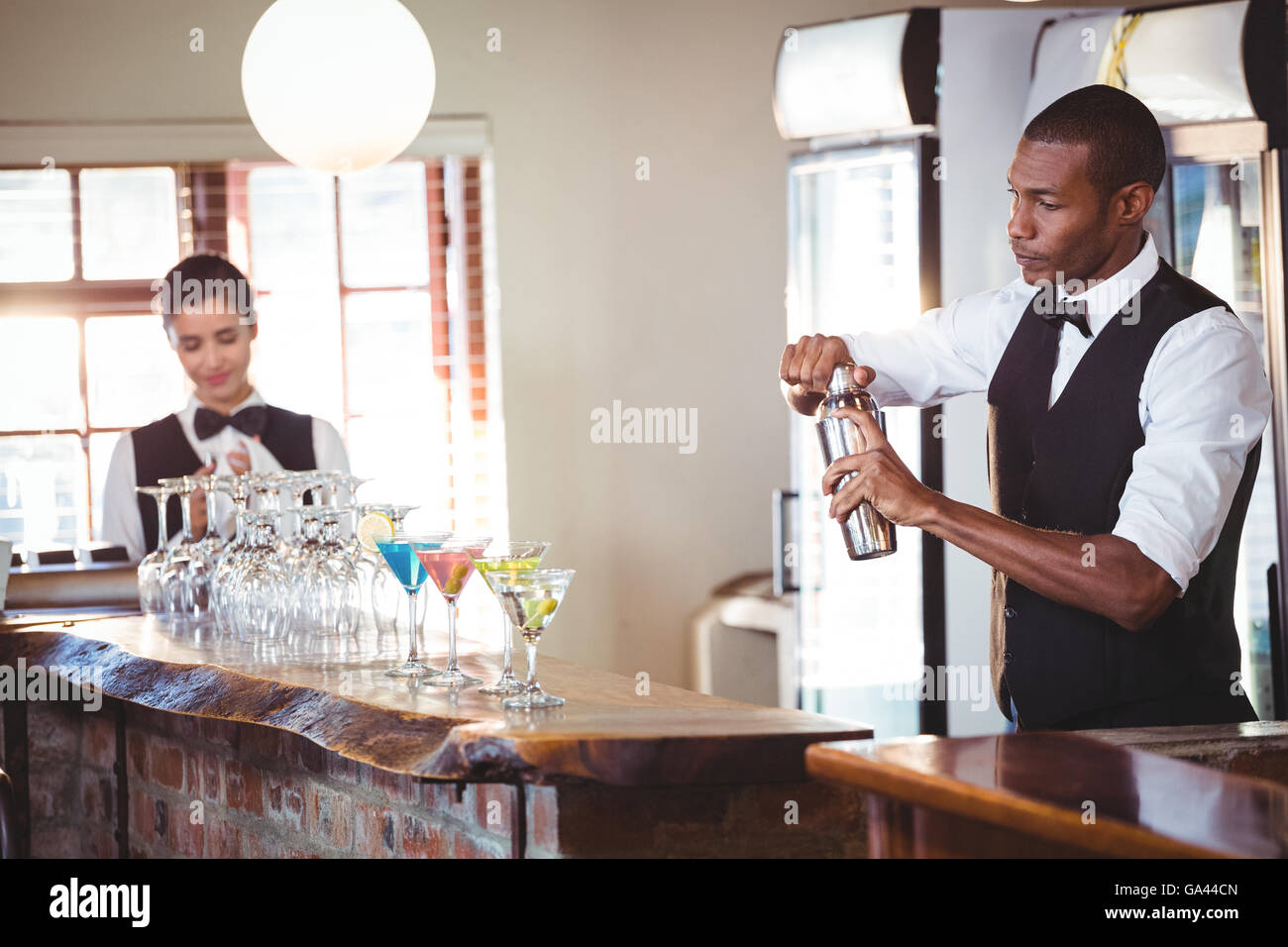 Bartender mixing a cocktail drink in cocktail shaker Stock Photo - Alamy