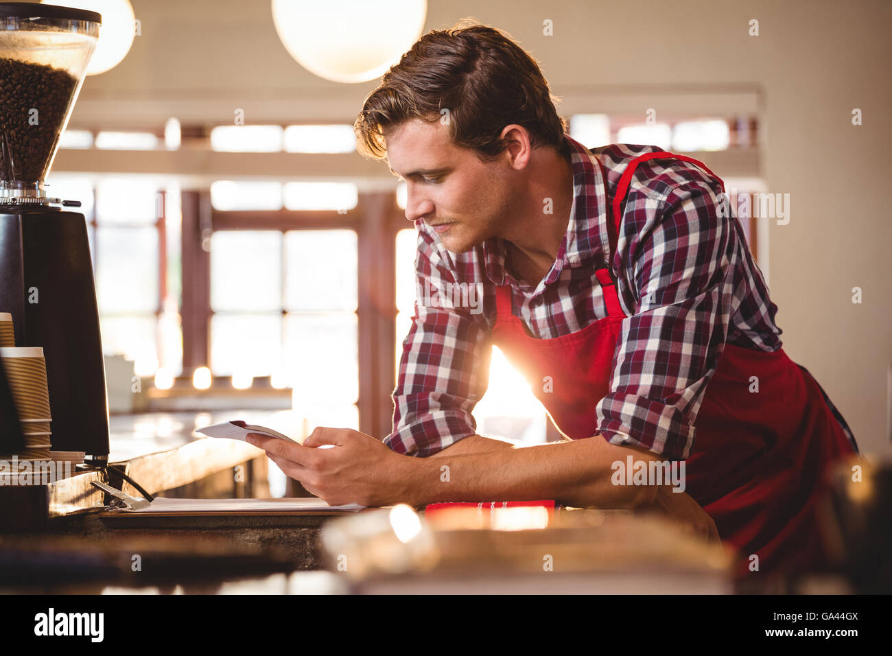 Waiter standing with notepad Stock Photo - Alamy