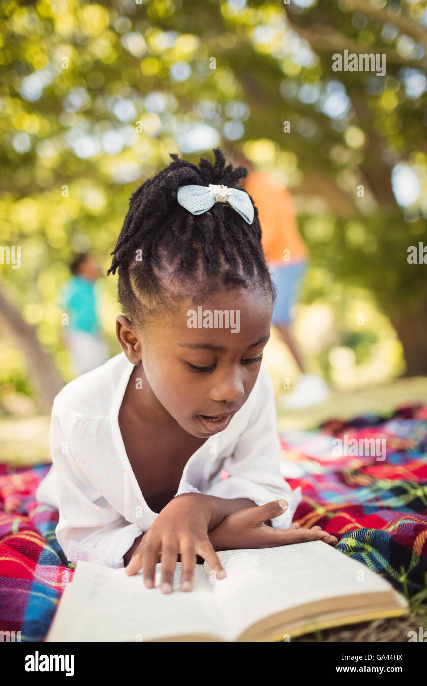 Happy girl reading a book Stock Photo - Alamy