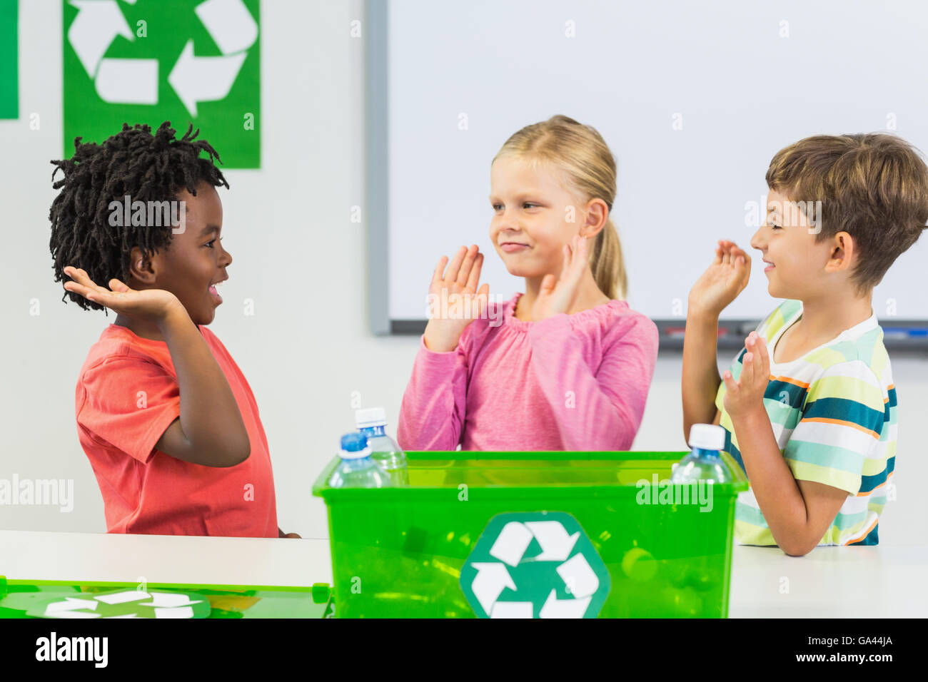 Kids giving high five to each other in classroom Stock Photo - Alamy