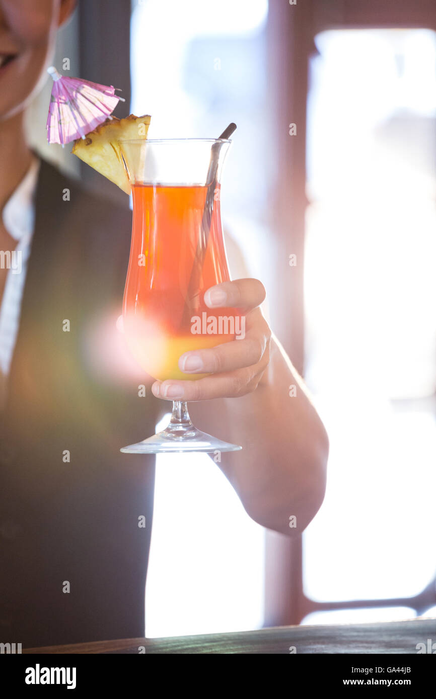Waitress handing over cocktails Stock Photo - Alamy