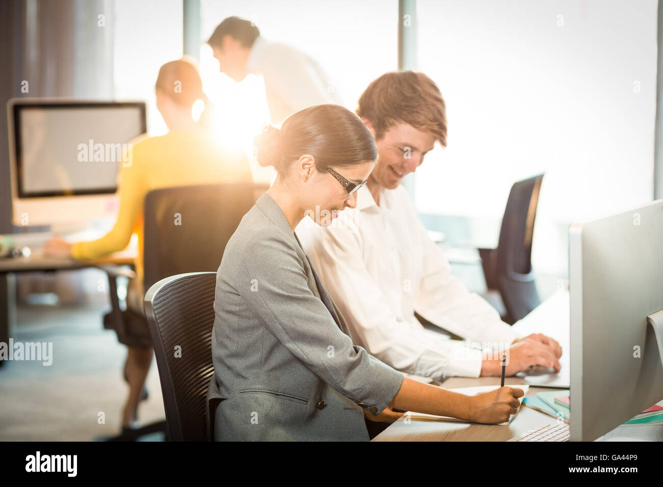 Businesswoman having a discussion with coworker Stock Photo - Alamy