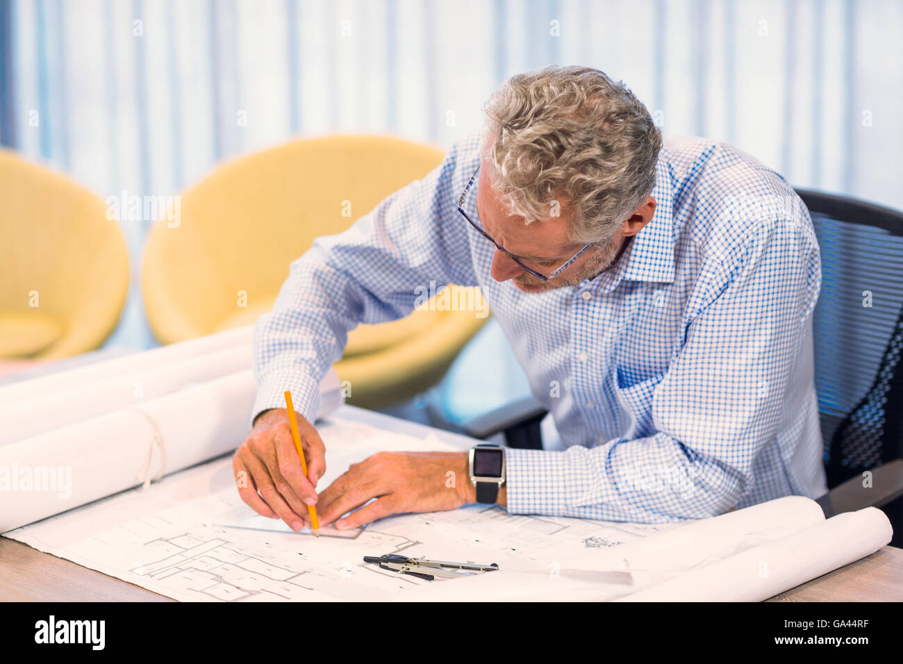 Man working on blueprint Stock Photo - Alamy