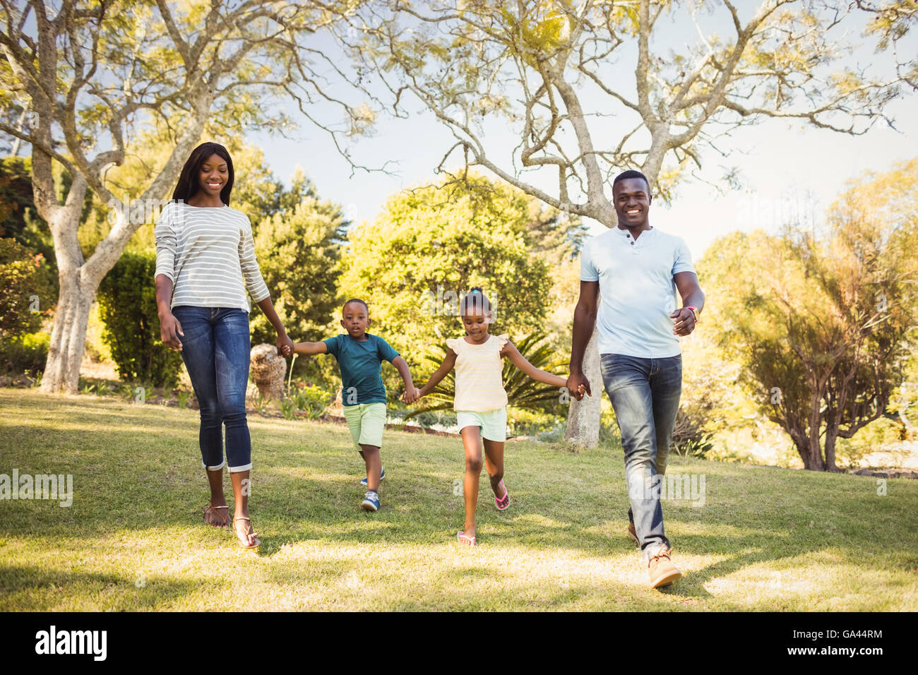 Happy family walking together Stock Photo - Alamy