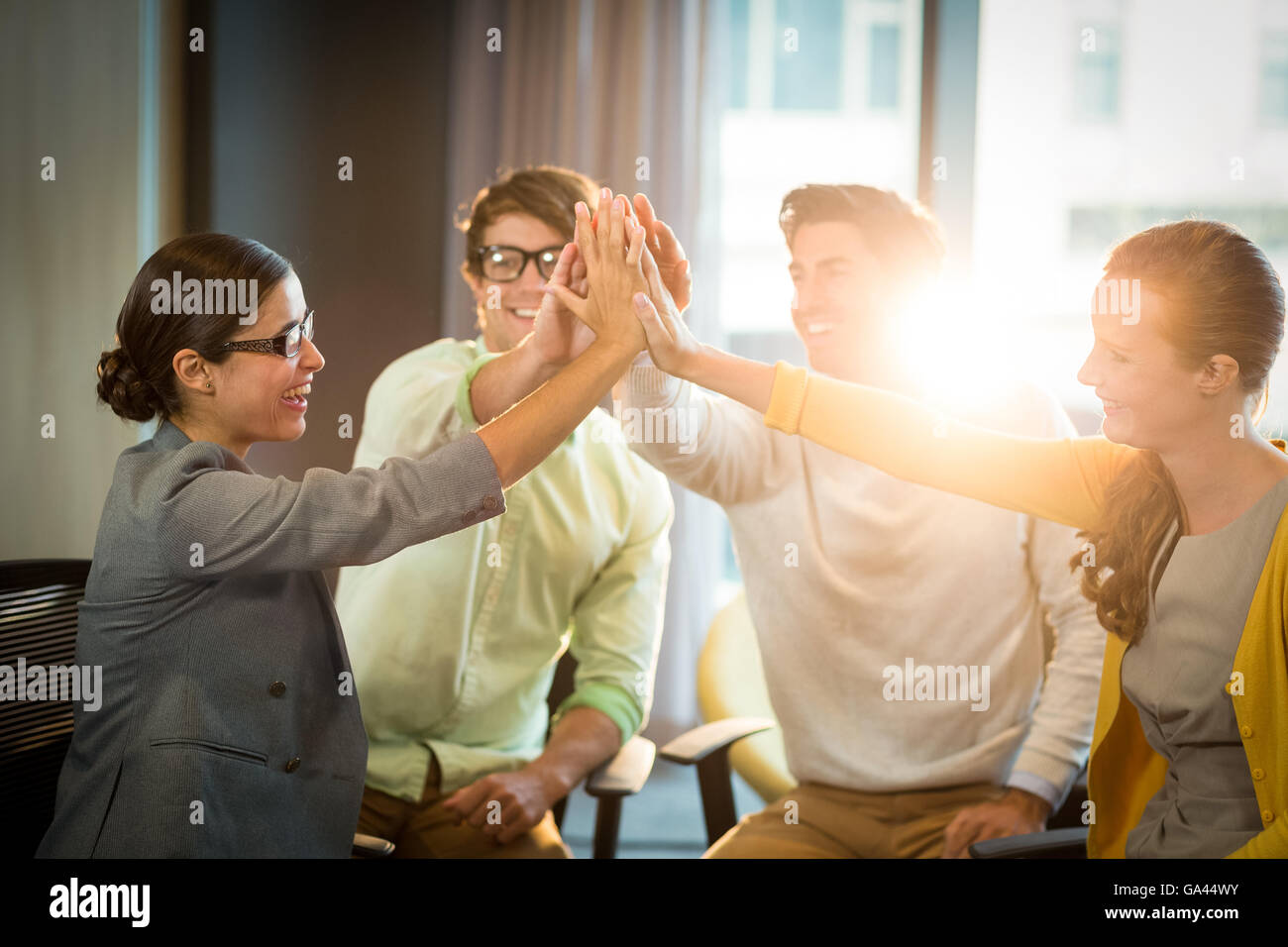 Business people giving high five to each other Stock Photo - Alamy