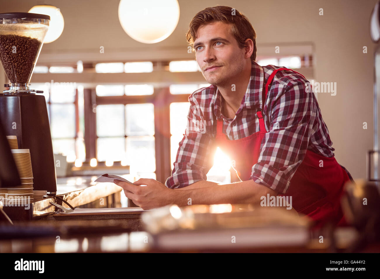 Waiter standing with notepad Stock Photo - Alamy