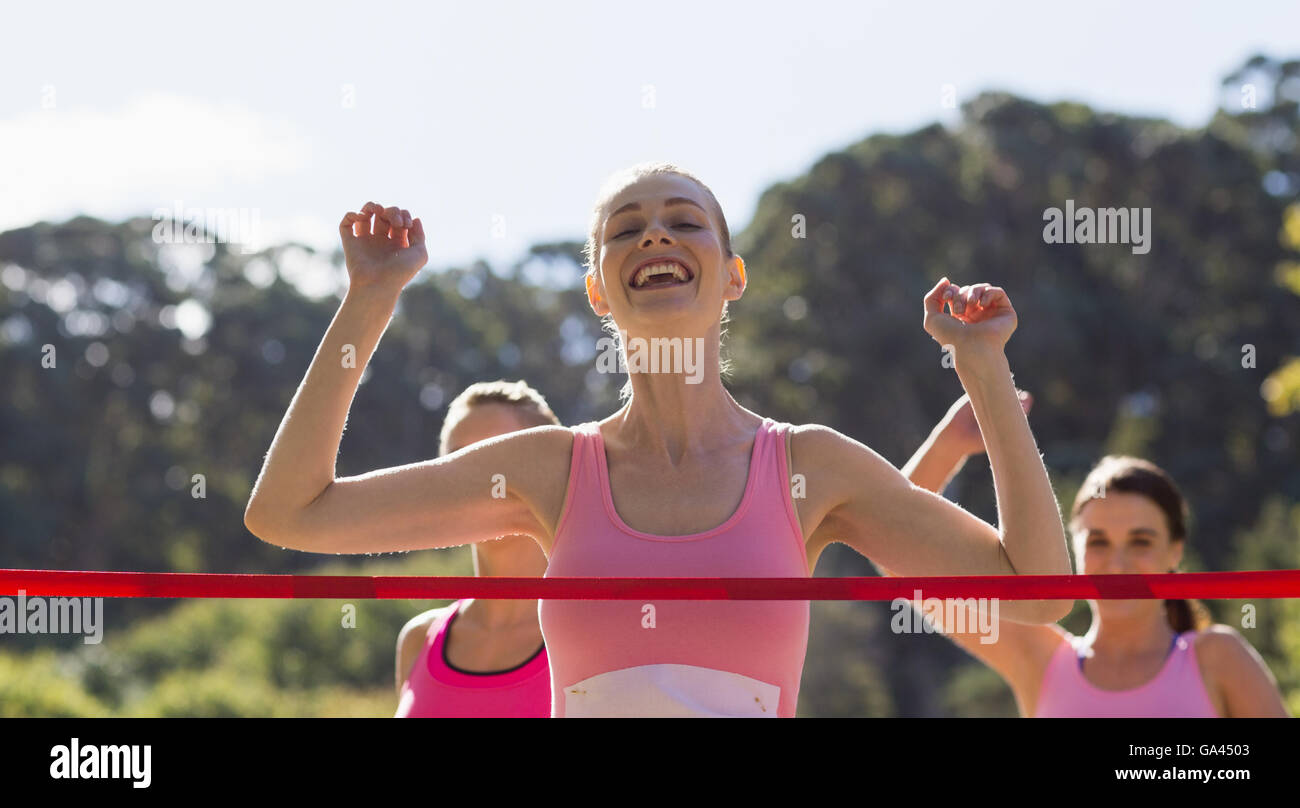 Female athlete crossing finish line hi-res stock photography and images ...