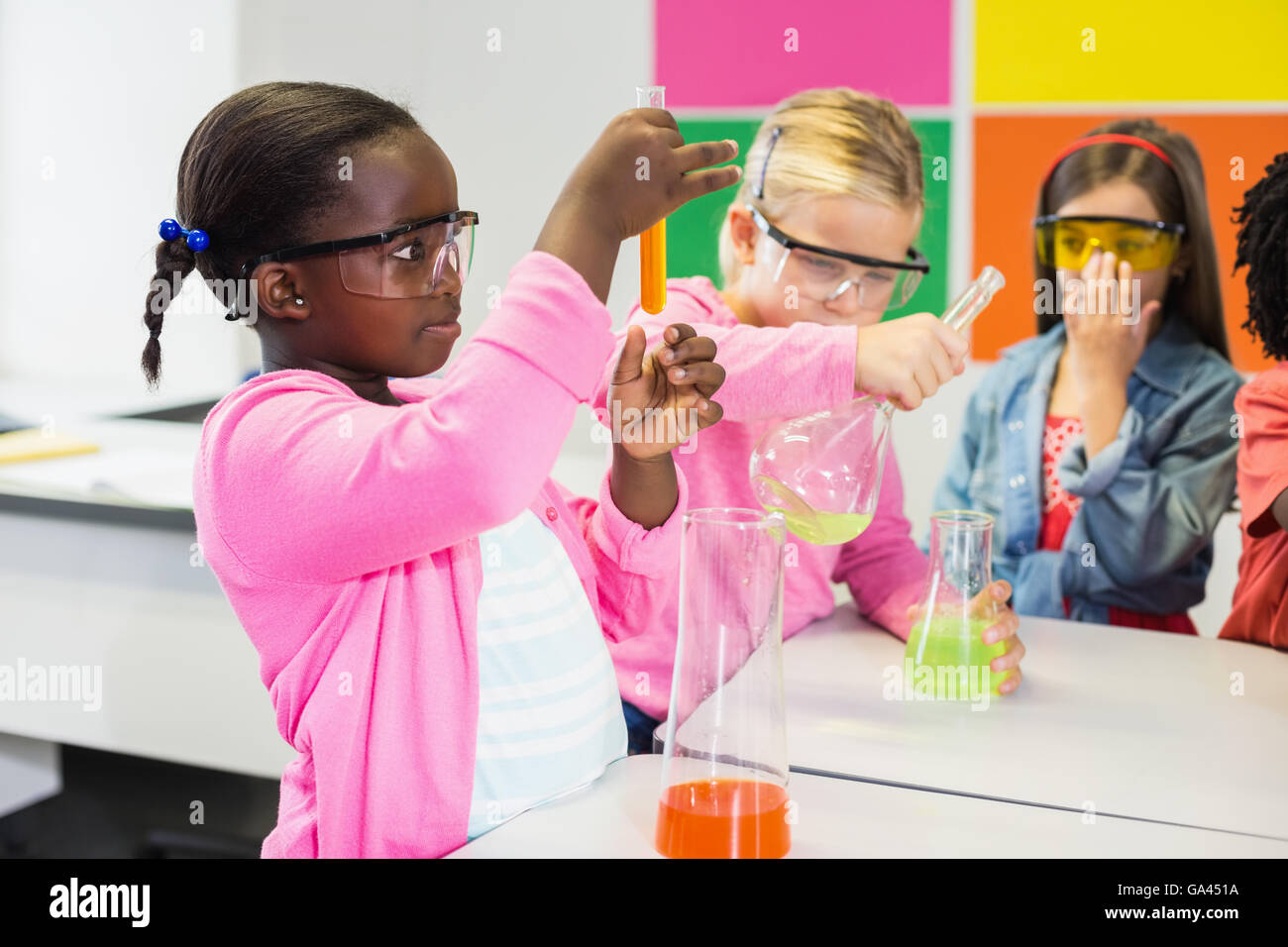 Kids doing a chemical experiment in laboratory Stock Photo - Alamy