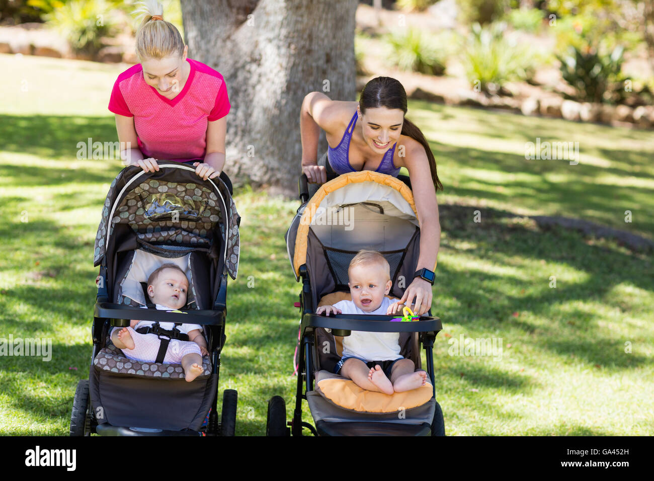 Women standing with the baby stroller Stock Photo - Alamy