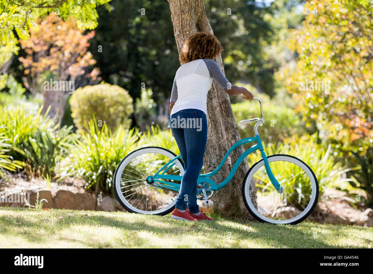 Rear view of woman parking her bicycle Stock Photo - Alamy