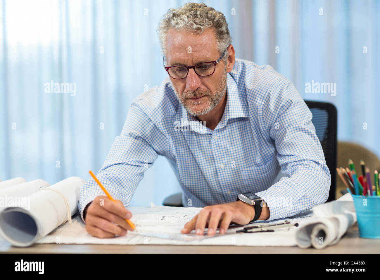 Man working on blueprint Stock Photo - Alamy