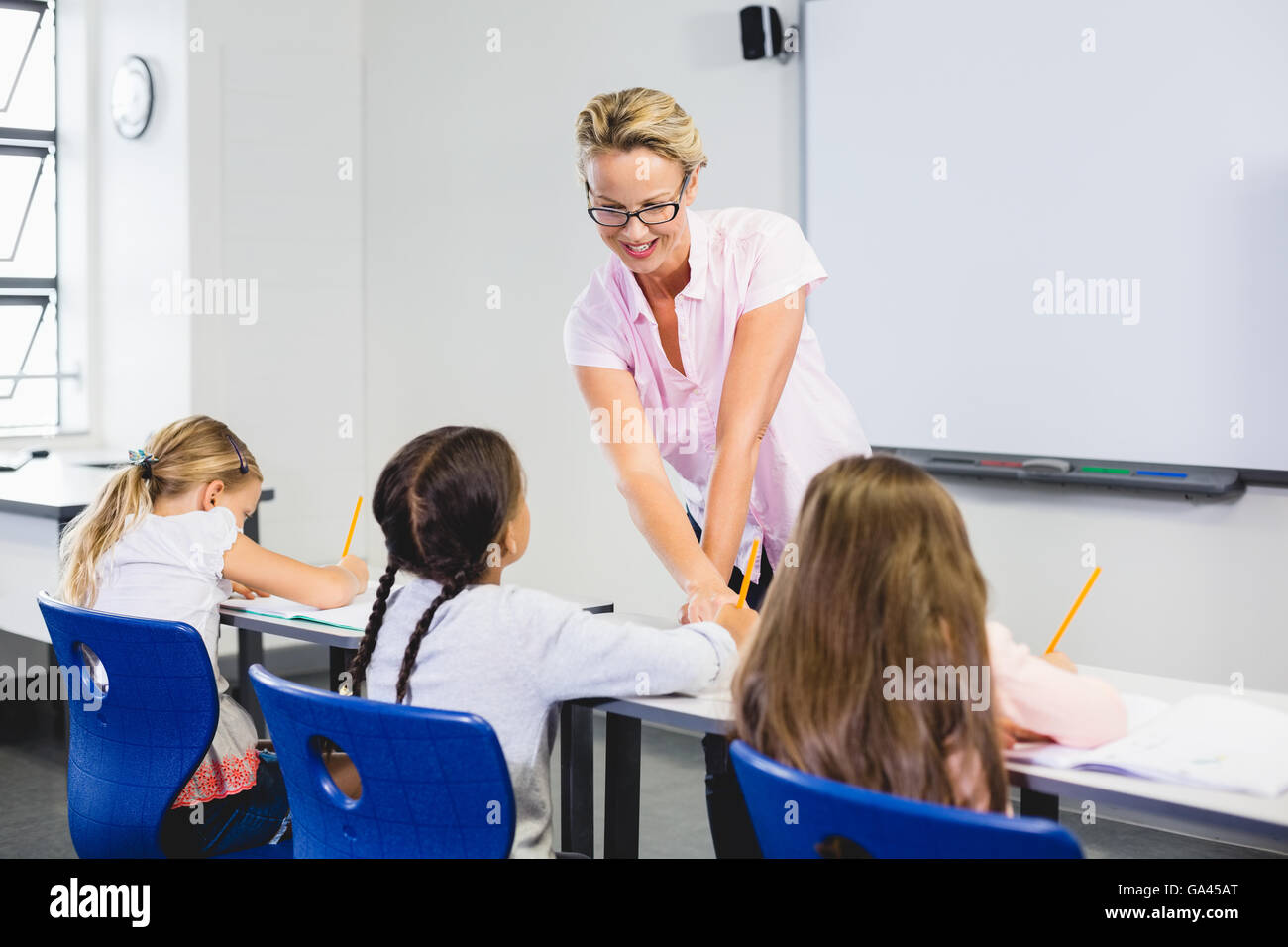 School kids talking in classroom hi-res stock photography and images ...