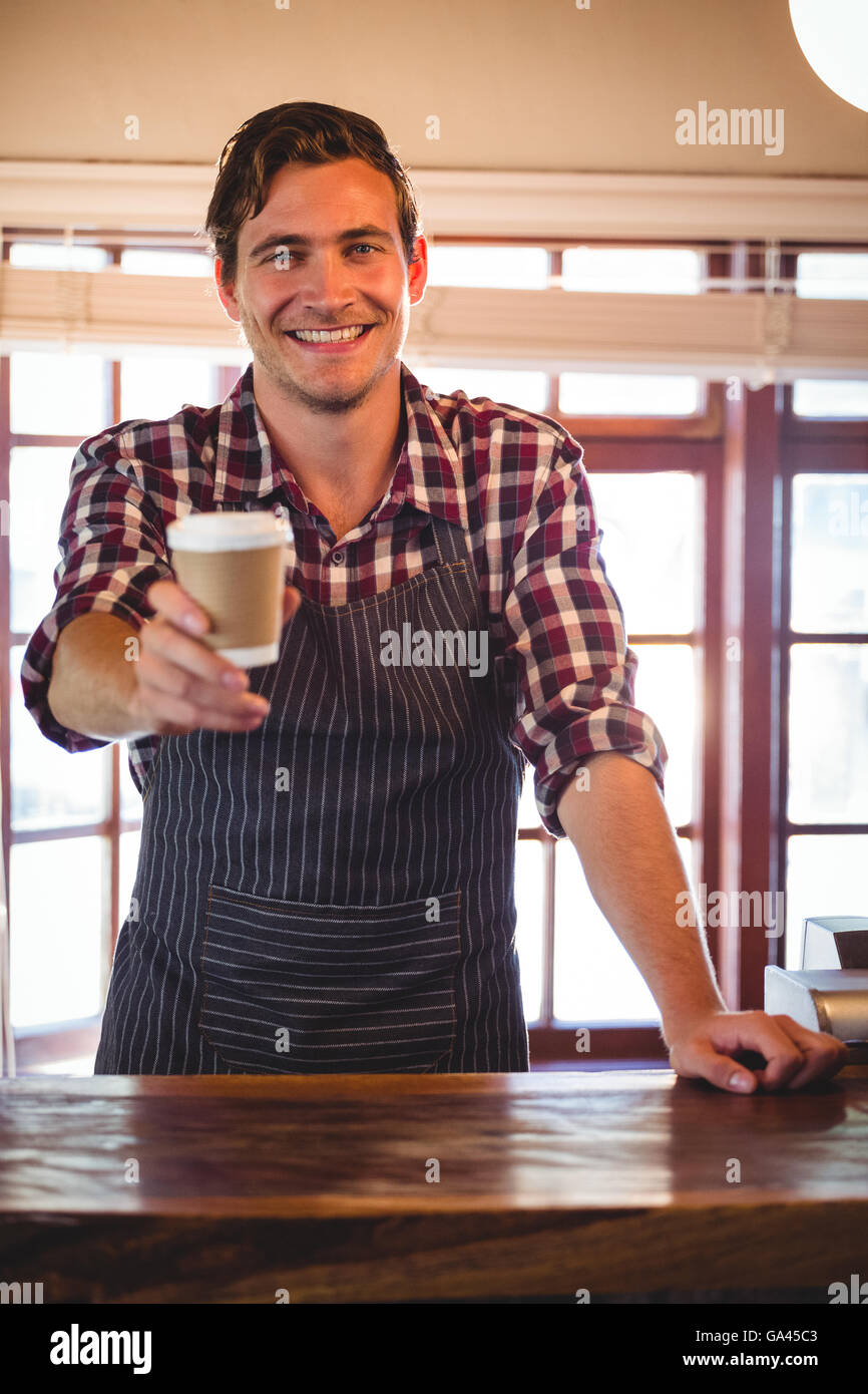 Portrait of waiter offering a cup of coffee Stock Photo - Alamy