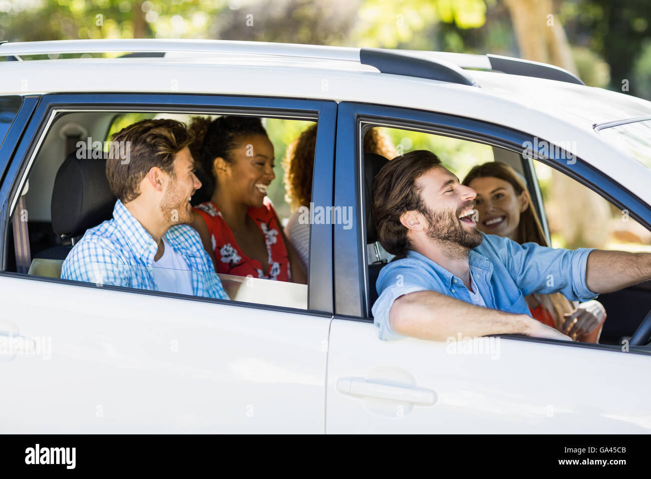 Group of friends having fun in car Stock Photo - Alamy