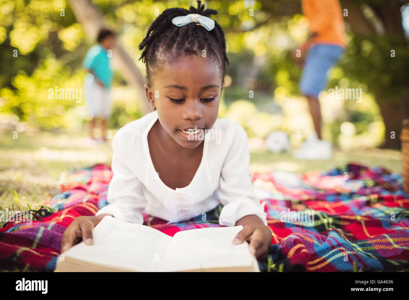 Happy girl reading a book Stock Photo - Alamy