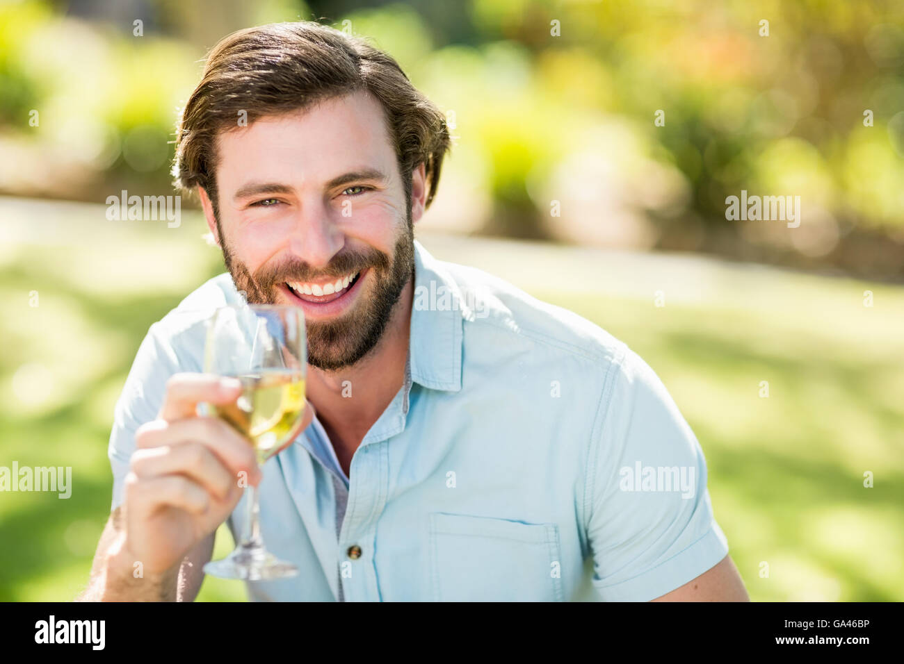 Portrait of man holding wine glass and smiling Stock Photo - Alamy