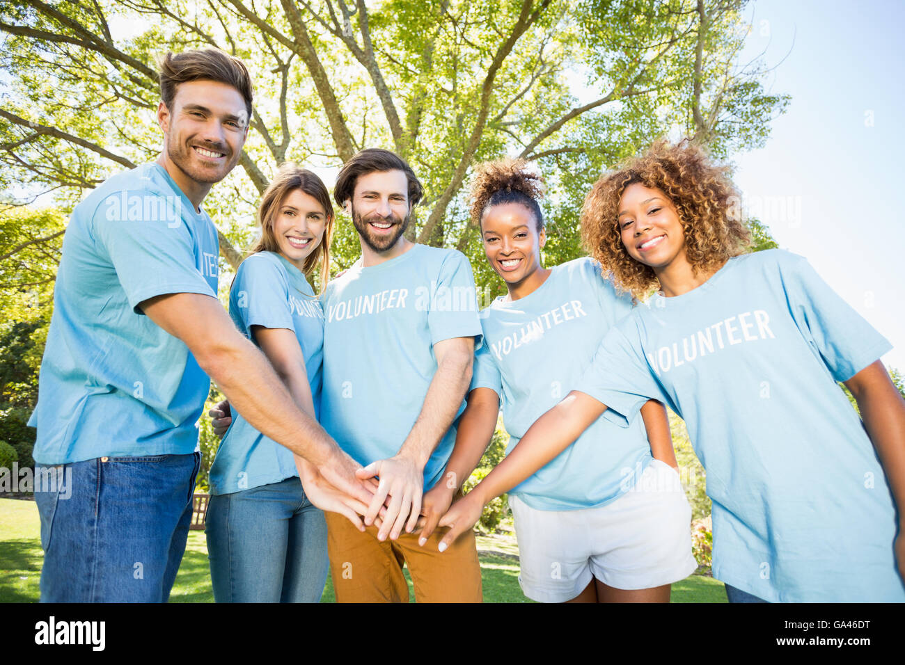 Portrait of volunteer group forming hands stack Stock Photo - Alamy